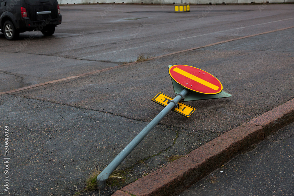Broken road sign "No entry" lying on the pavement Stock Photo | Adobe Stock