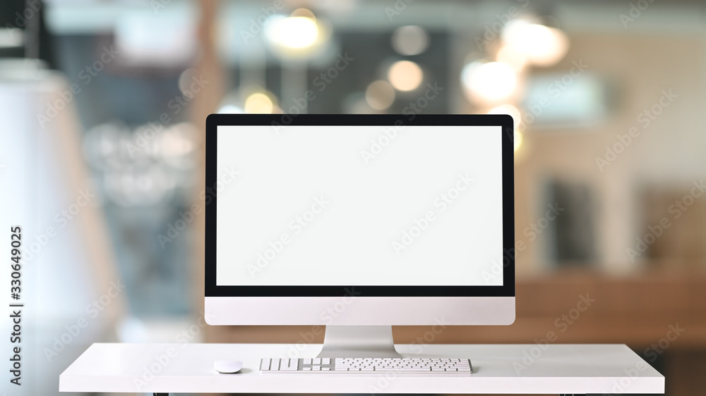 Computer monitor with white blank screen putting on white working desk ...