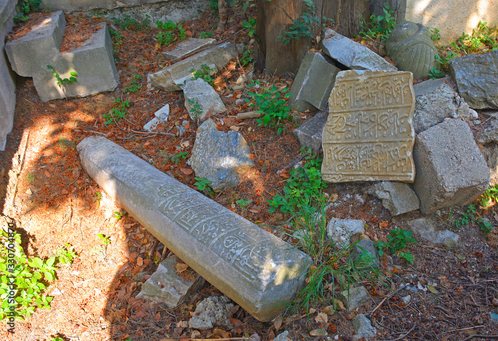 Historic broken grave stones with Ottoman Turkish script in Karacaahmet ...