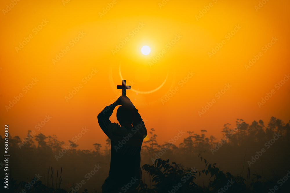 human kneeling down and raise the cross on the head for praying and ...