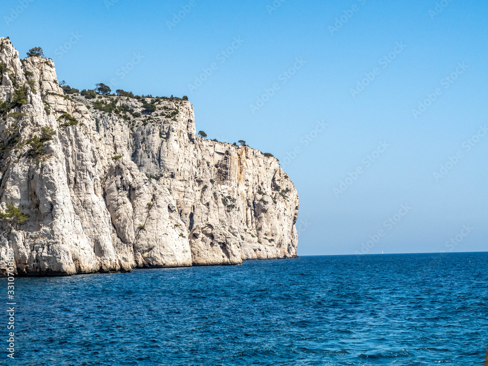 Calanques or narrow inlets formed by steep limestone cliffs near Cassis ...