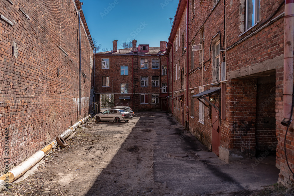 The courtyard of an old brick apartment building abandoned since Great ...