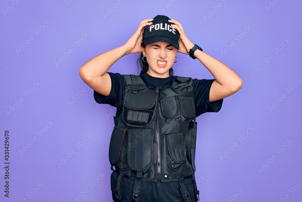 Young police woman wearing security bulletproof vest uniform over ...