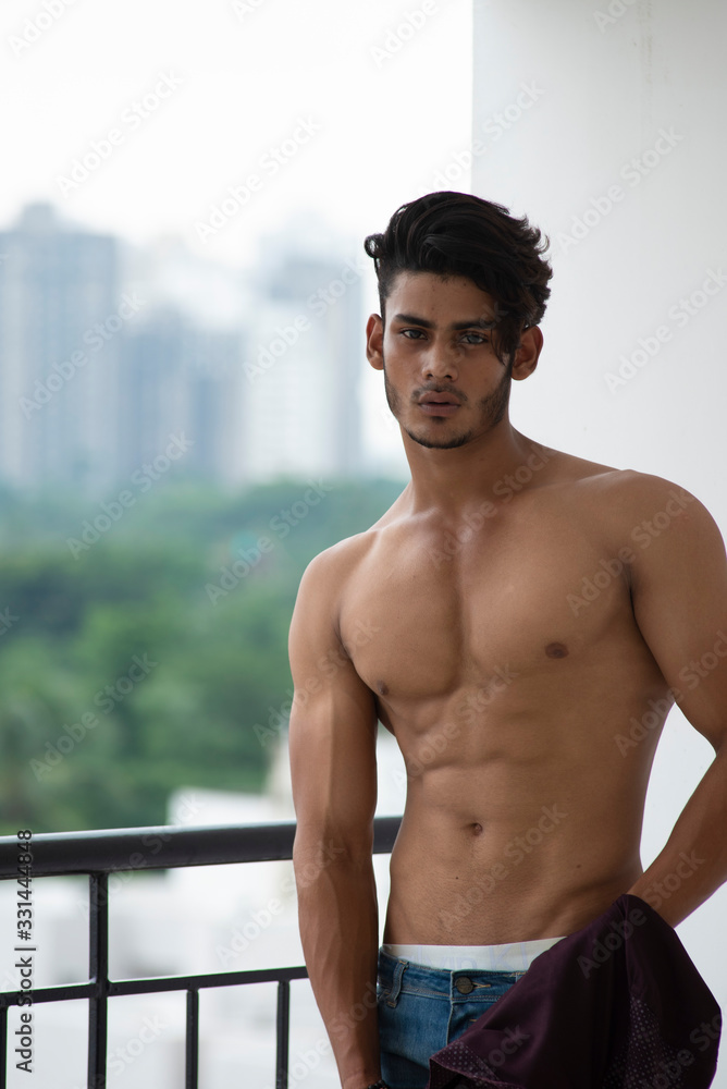 Portrait of an young and handsome brunette Bengali muscular man ...