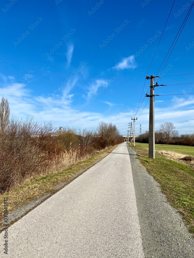 asphalt road, power line, energy pylon, high voltage, field, sky ...