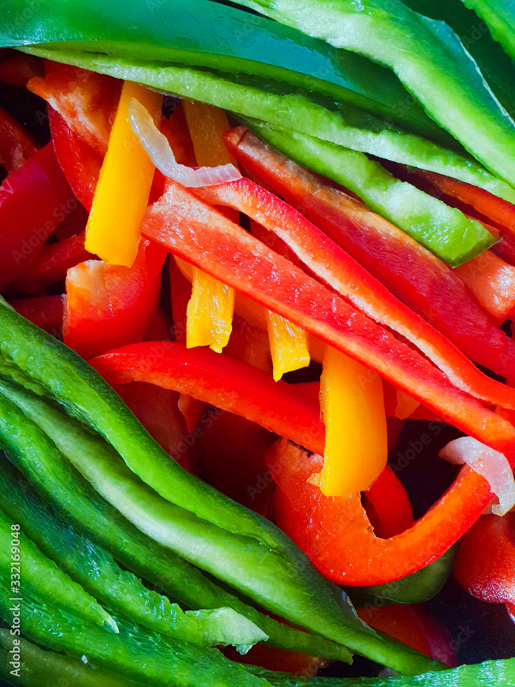 Vertical background of julienned bell peppers. Red and green pepper ...