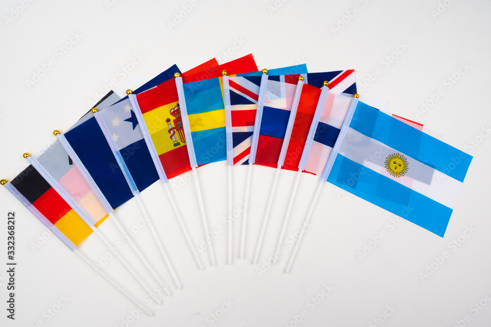 Miniature flags of the countries of the world on the white table ...