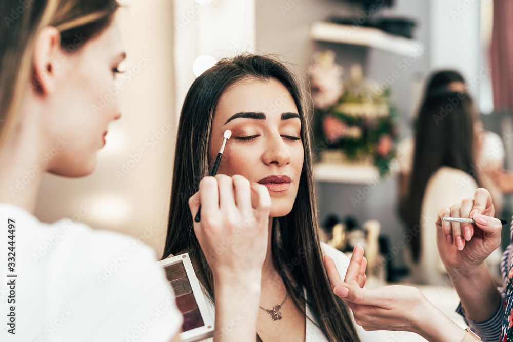 Professional makeup artist teaching student in makeup school. Stock ...