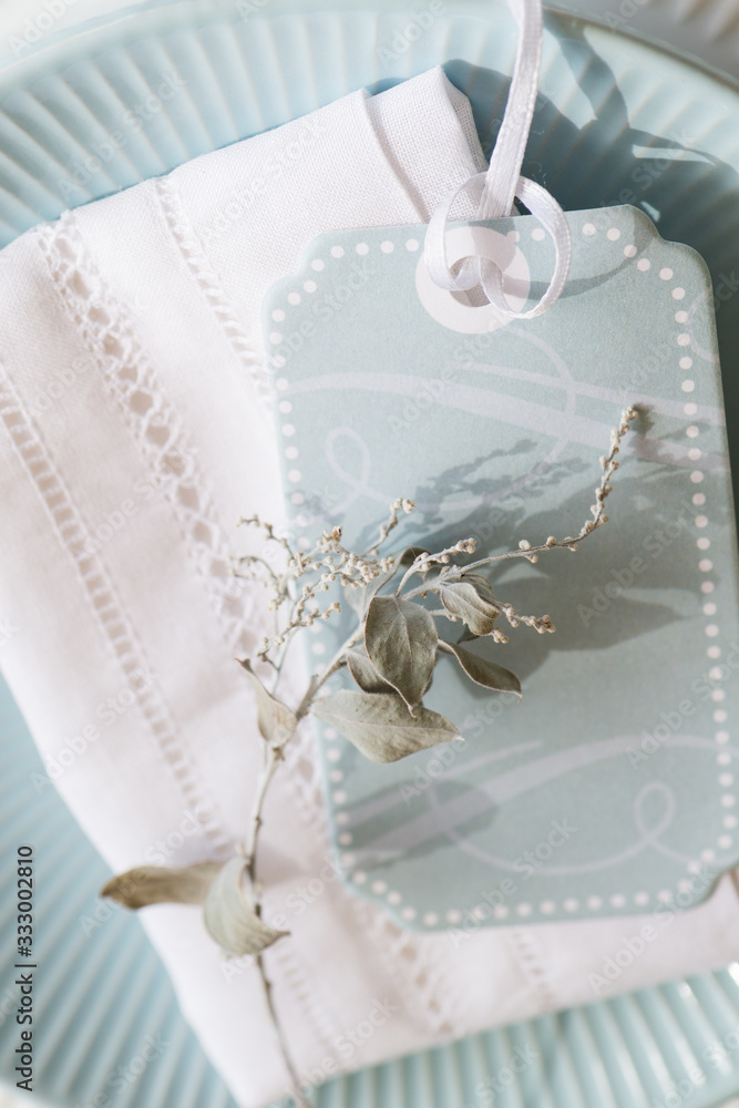 table setting with blue tag and dry gum leaf Stock Photo | Adobe Stock