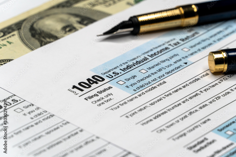 ภาพถ่าย Stock Tax form with pen and dollar banknote. document are mock ...
