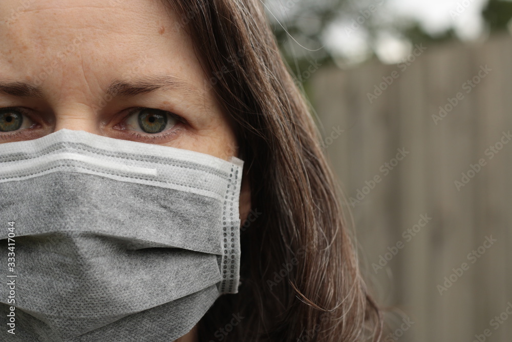Young Australian woman wearing a paper surgical protective face mask to ...