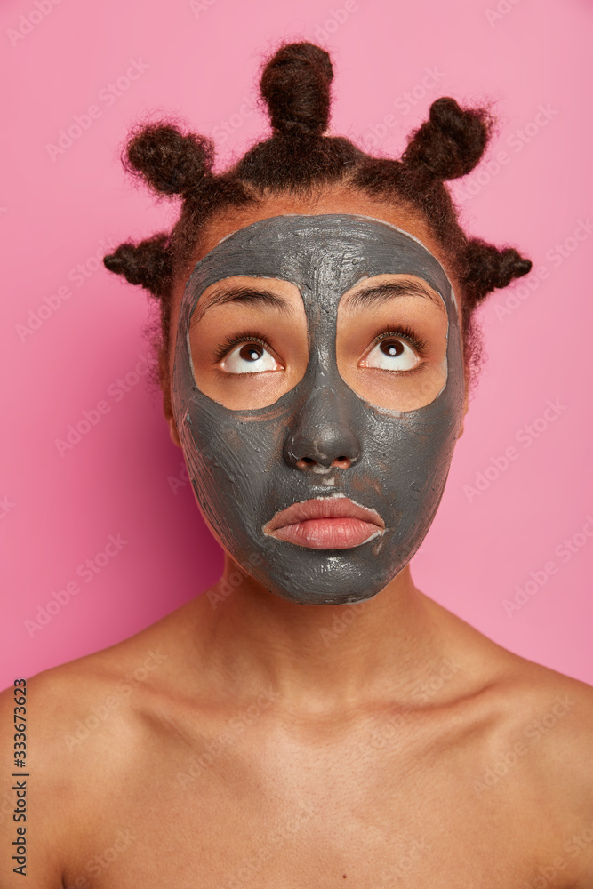 Vertical photo of sad embarrassed woman concentrated above, wears ...