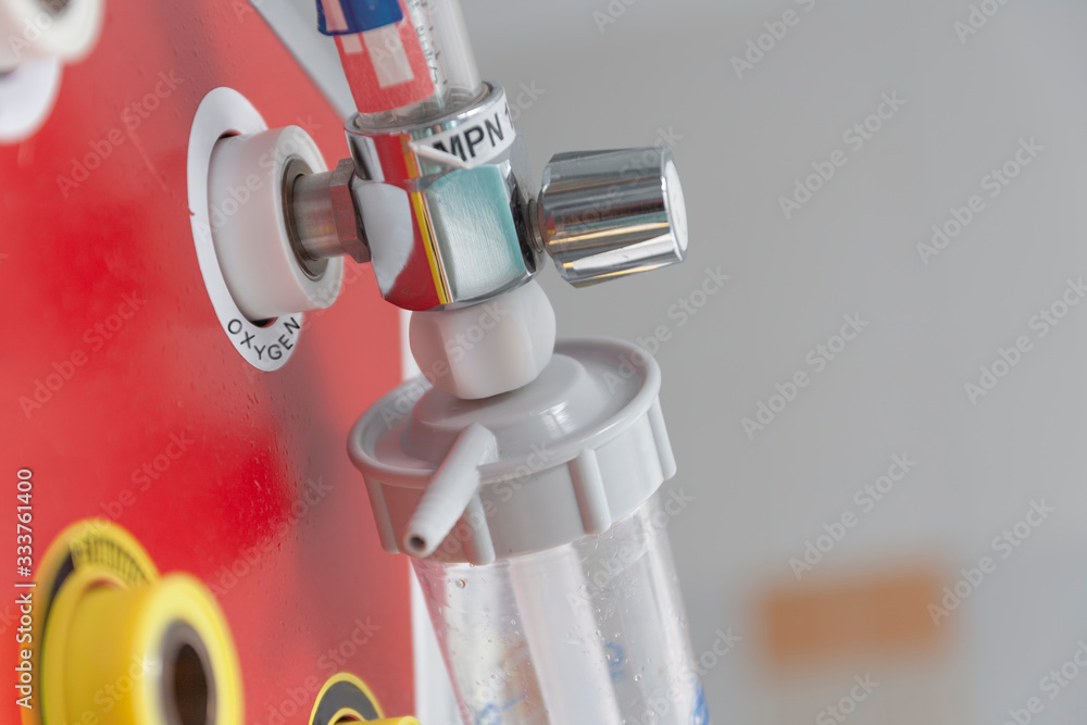 Medical oxygen flow meter with humidification bottle. Oxygen therapy is ...