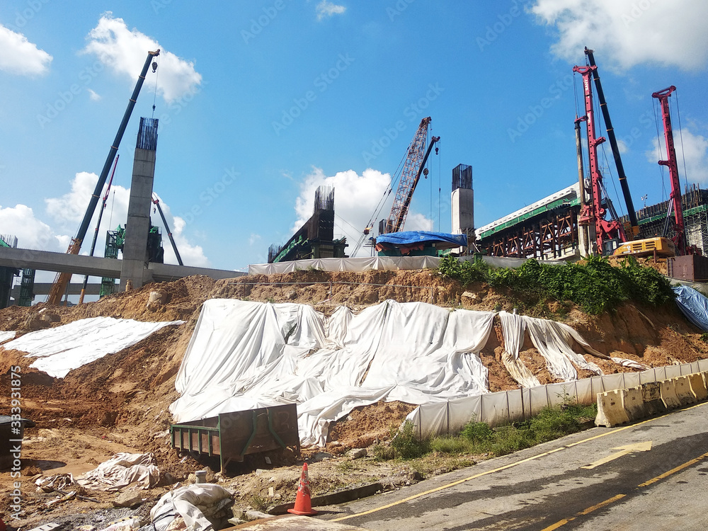 The geotextile fabric is spread over the surface of the slope to ...