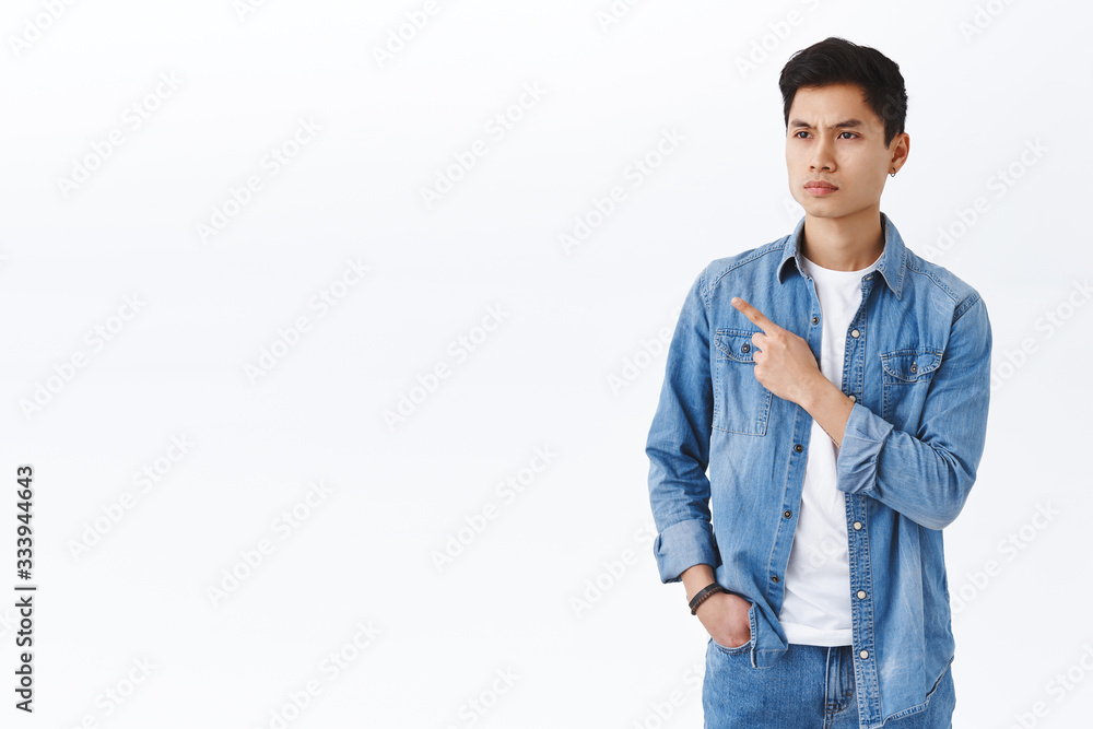 Portrait of judgemental, serious-looking skeptical young asian guy look ...