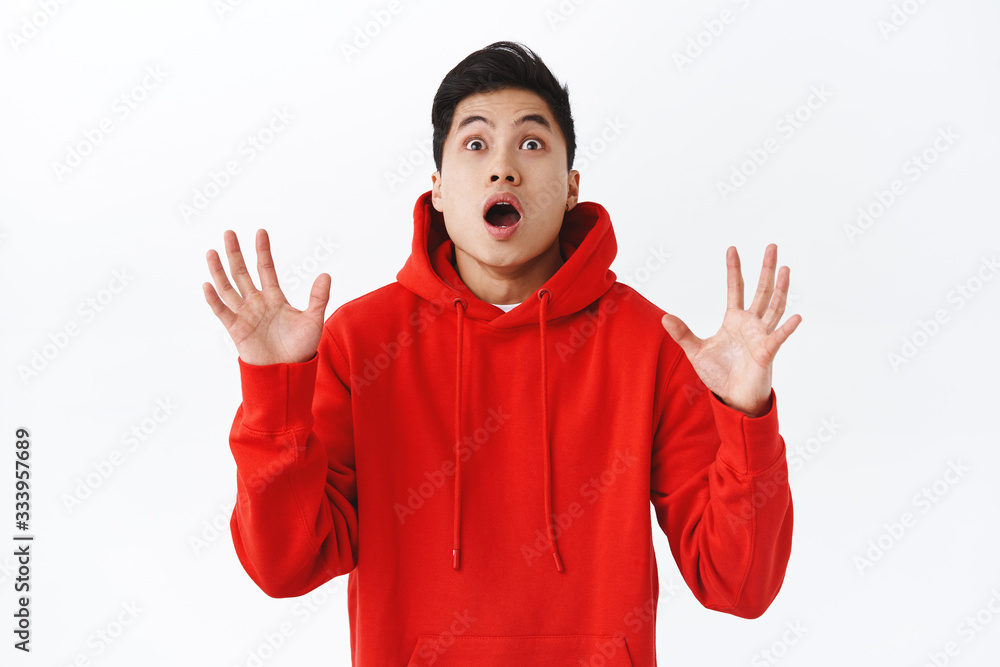 Waist-up portrait of shocked, startled asian man raise hands to catch ...