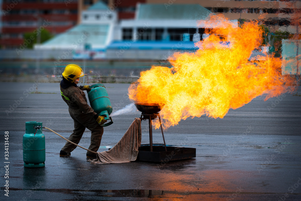 Firefighters under training open gas and fire to show danger from fire ...