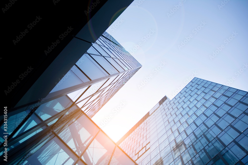 Skyscraper, modern building in the city with sunlight. Glass wall of an ...