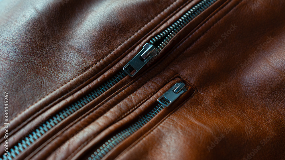Brown textured leather jacket zippers. Background of brown leather ...