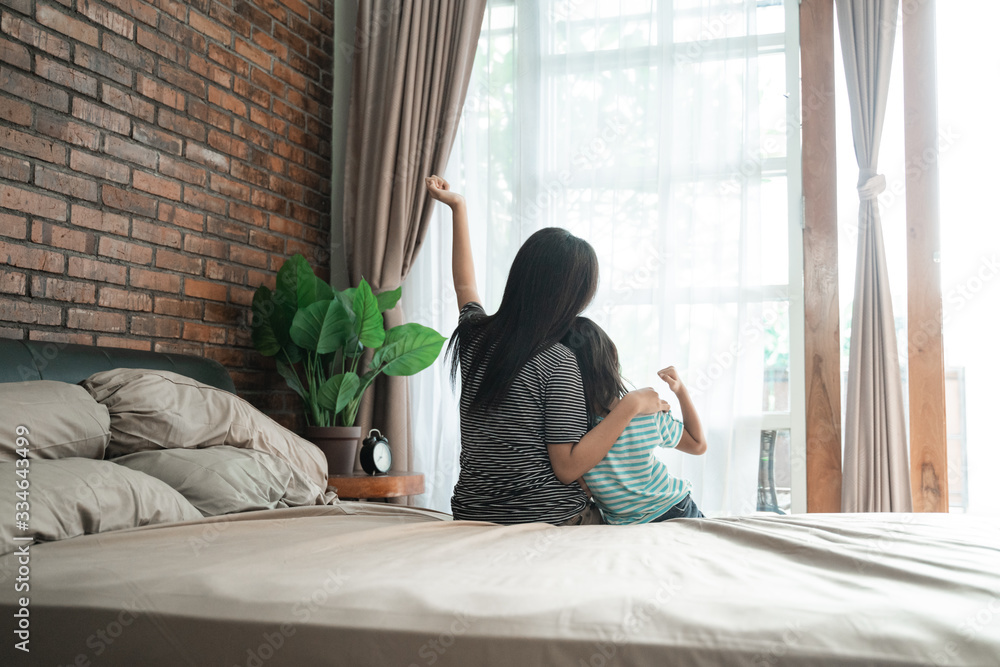 asian cute sibling sitting on the bed hold hand and looking at the ...