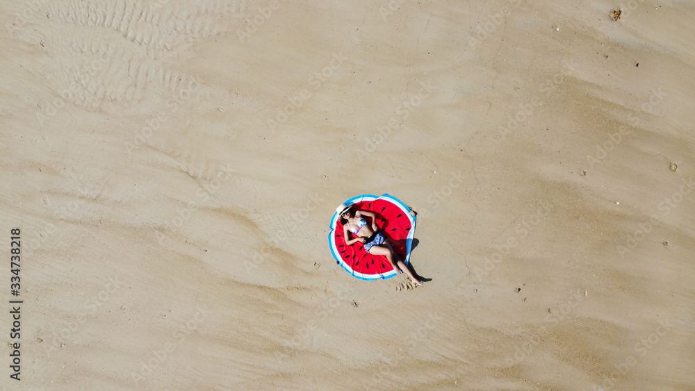 Young woman lying on the beach blanket, sunbather on white sand, Top ...