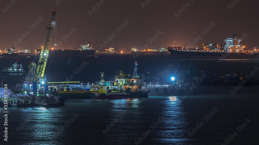 Singapore Marina Barrage with cargo ships waiting to enter one of the ...