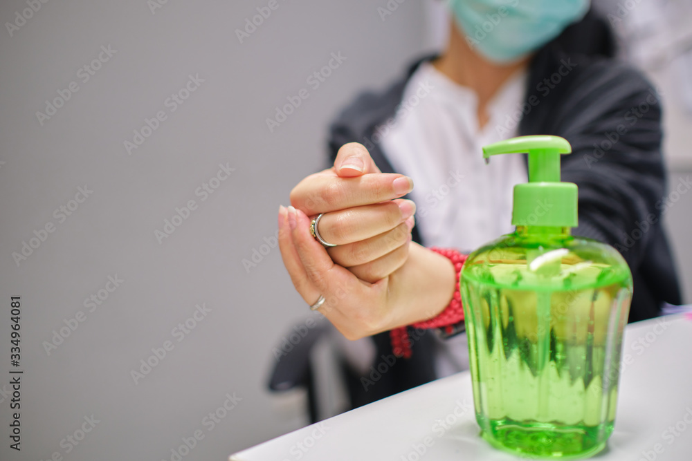 Clean hand alcohol gel sanitizer pump in office for hygiene protect ...