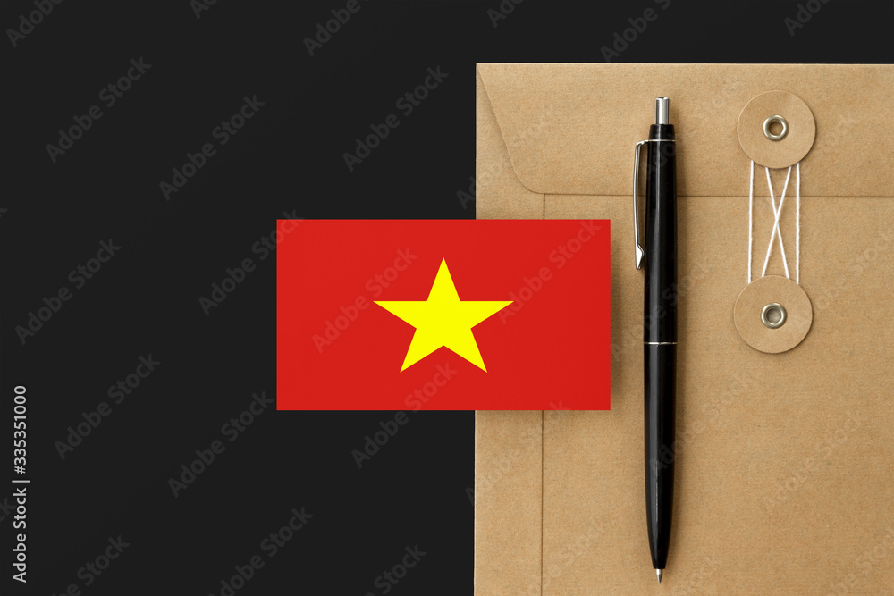 Vietnam flag on craft envelope letter and black pen background ...
