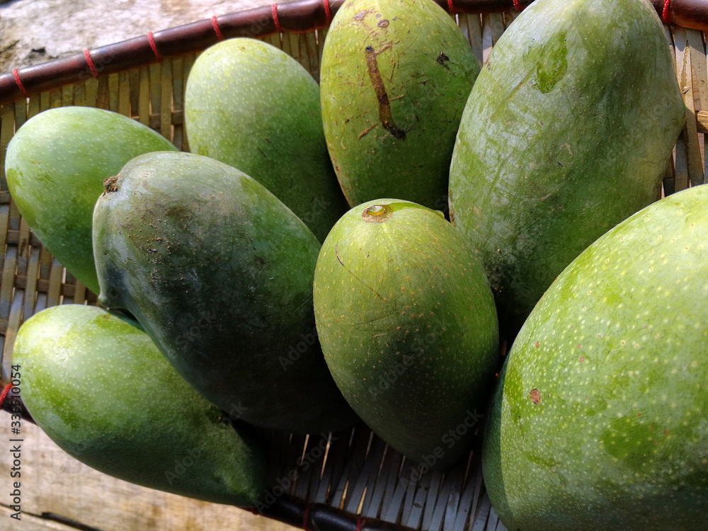 green mango on basket and old wooden desk ,group of mangoes fruit, sour ...