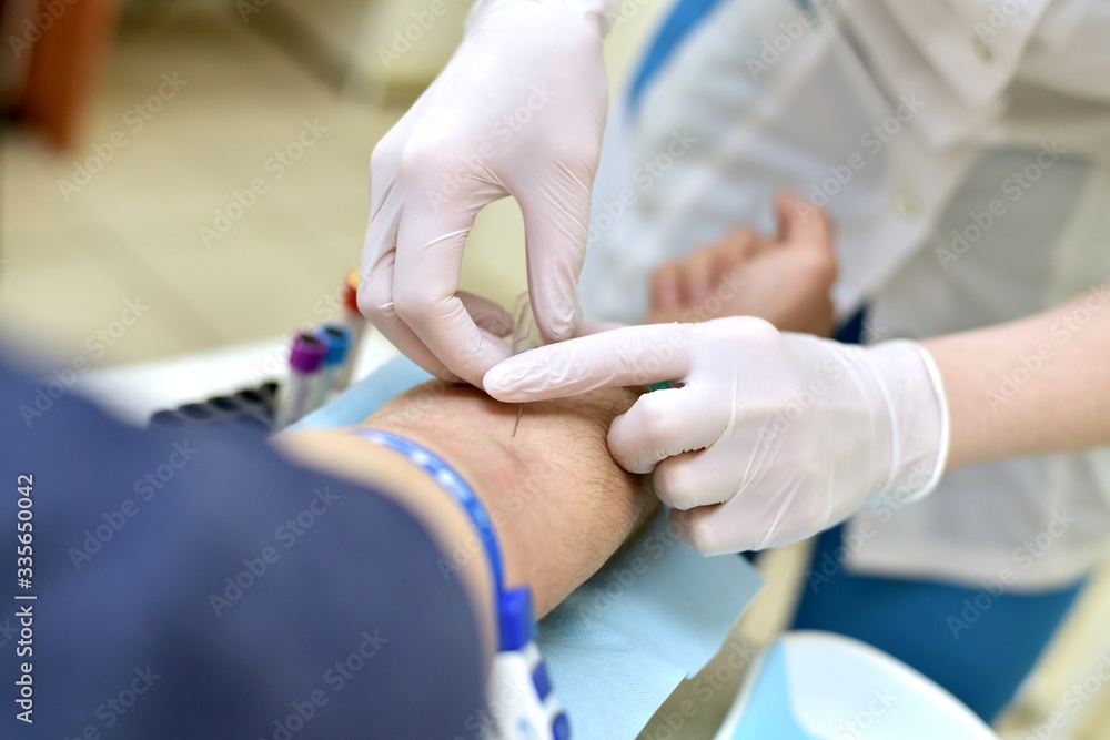 Taking venous blood from a patient in a laboratory. Puncture step of ...