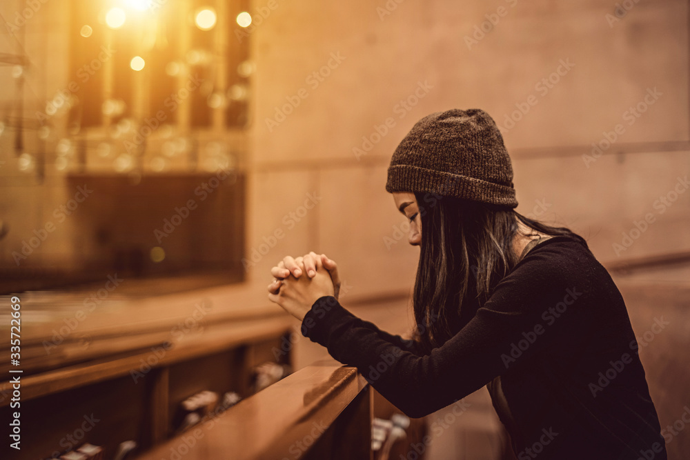Young woman prayer's pray alone in church, People pray to God with ...