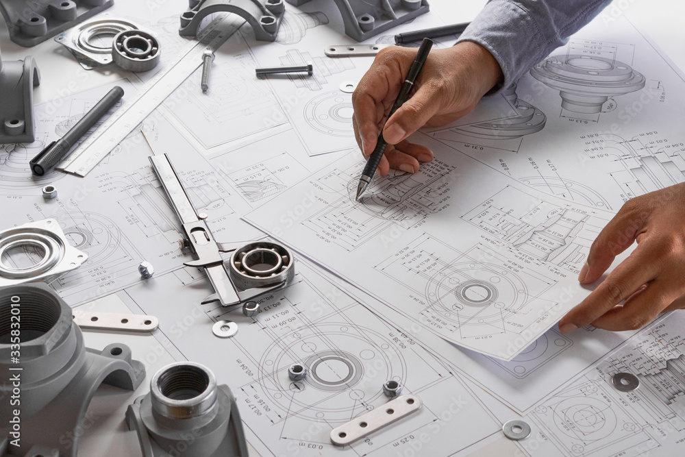 Engineer technician designing drawings mechanical parts engineering ...