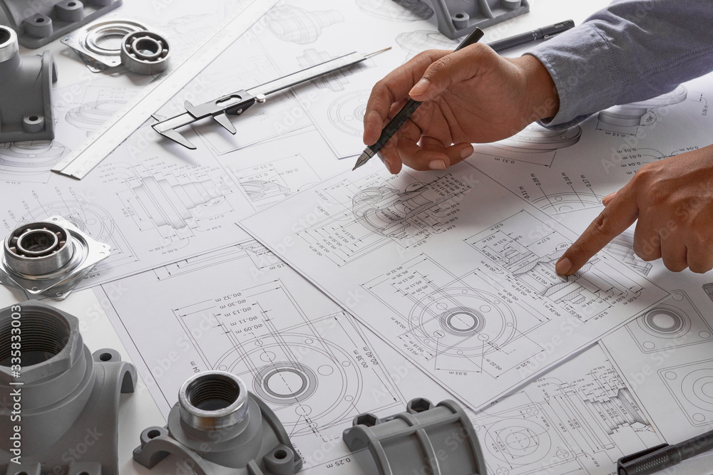 Engineer technician designing drawings mechanical parts engineering ...