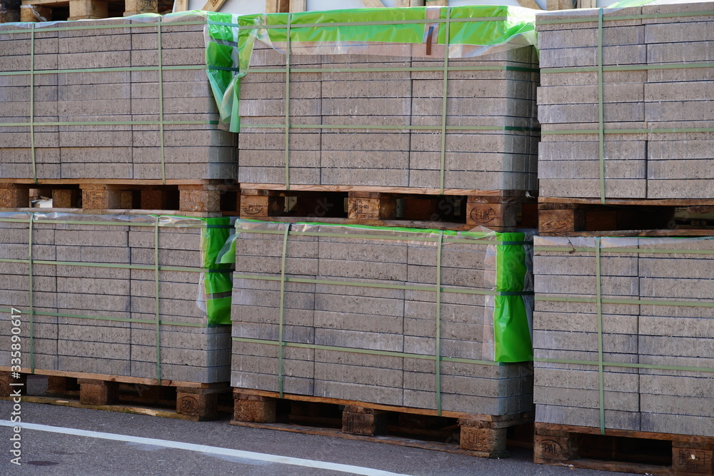 Concrete plates stapled and attached on six pallets by plastic bands in ...