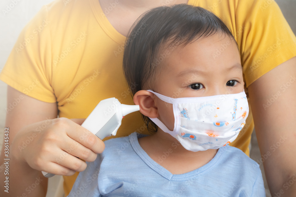 Measuring temperature of little boy,mother or doctor checks little 's ...