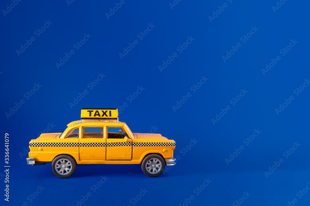 Model of yellow retro New York city taxi cab against a dark blue ...