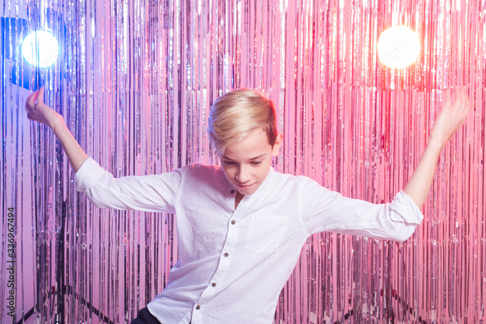 Teen boy dancing hip-hop on shiny background. Dance and child concept ...