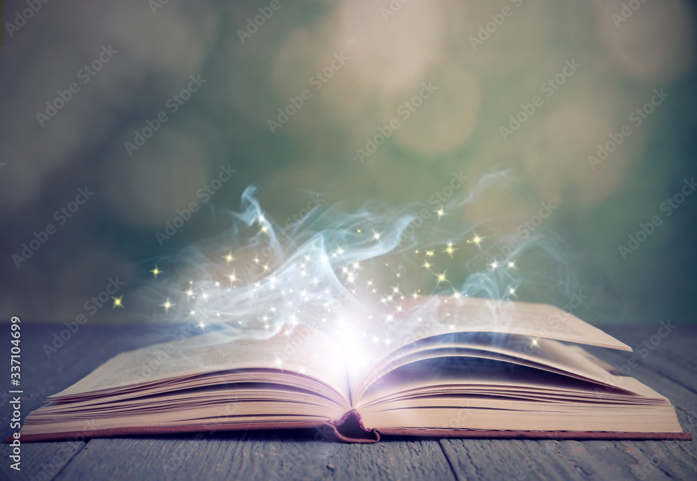 Open book with magic glowing on wooden table. Fairy tale Stock Photo ...