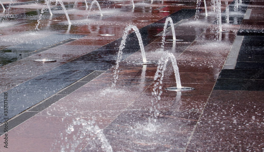 Arched fountains create an artistic design in this urban splash pad ...