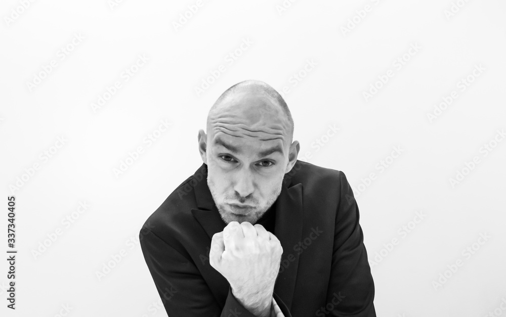 Stock-Foto „bald business boss in blue suit is showing big fist and ...