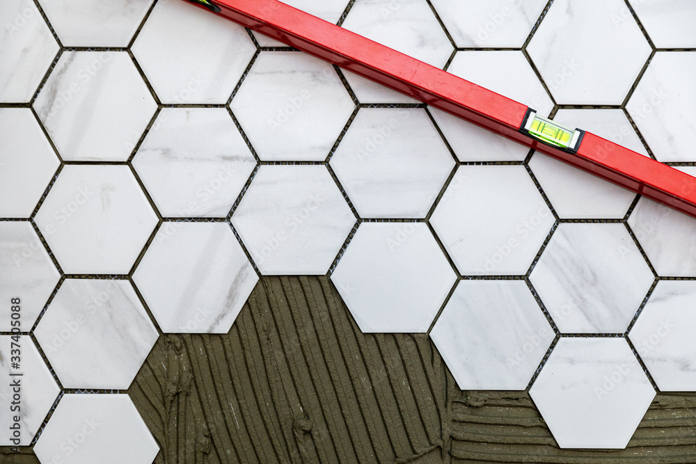 tiling - laying marble texture hexagon tiles on the floor Stock Photo ...