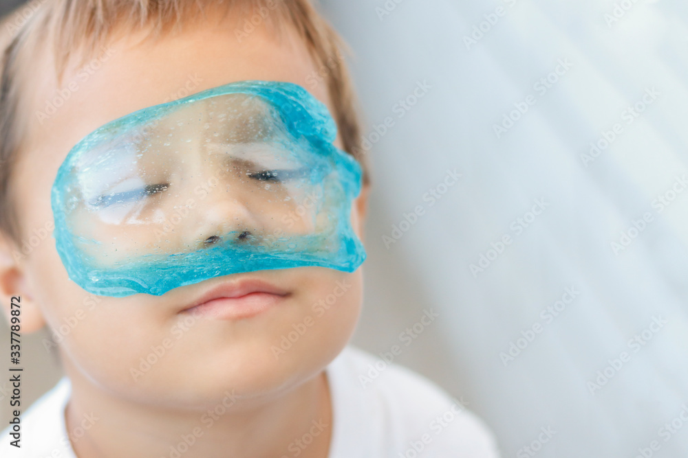 The kid plays a handmade toy called slime. Children play with big blue ...