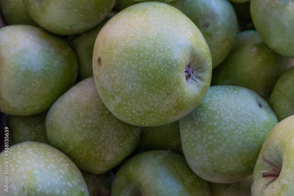 Multi-colored apples in a box. Selling crops on the market. Natural ...