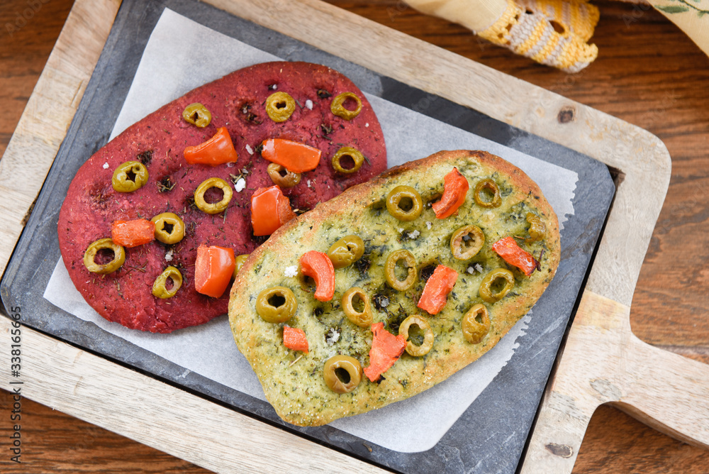 variety of different focaccia, with pumpkin, carrot and beet, on a ...