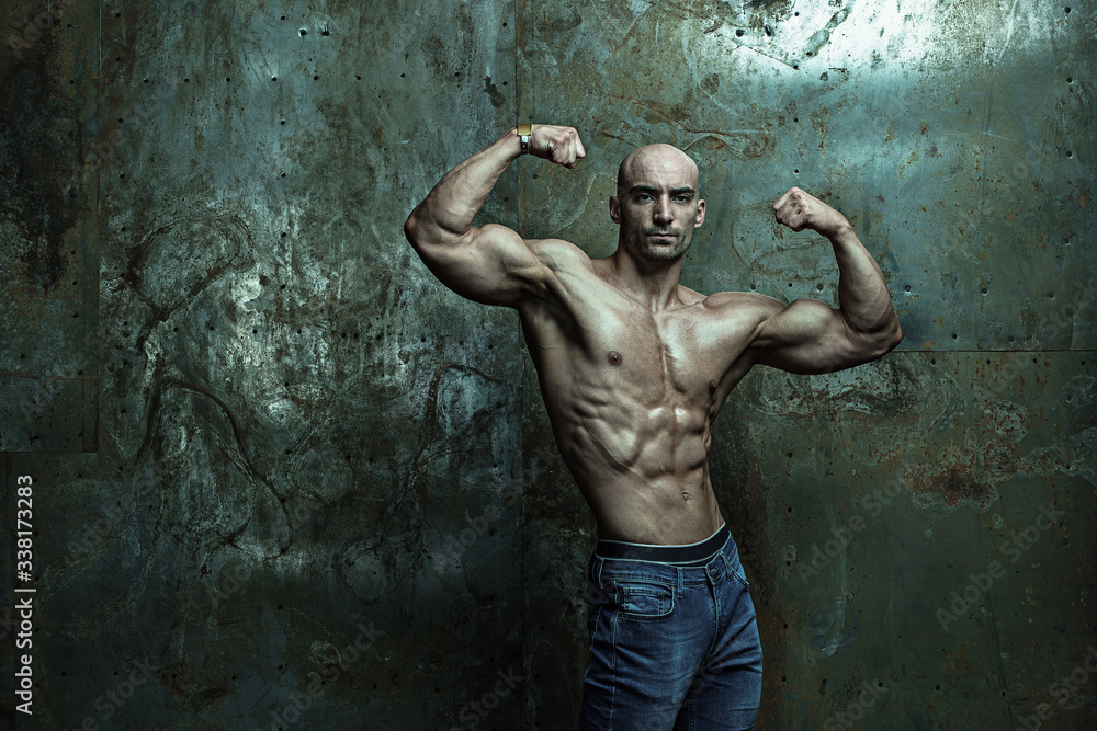 Strong bald bodybuilder with six pack. Bodybuilder man with perfect abs ...