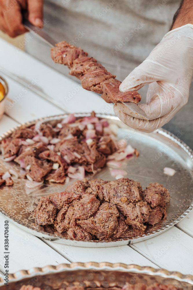 Process of making kebab. Meat on skewer. Cooker follow hygiene and use ...