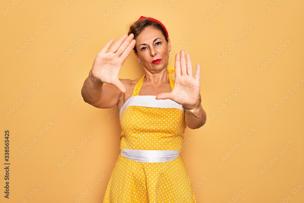 Middle age senior pin up woman wearing 50s style retro dress over ...