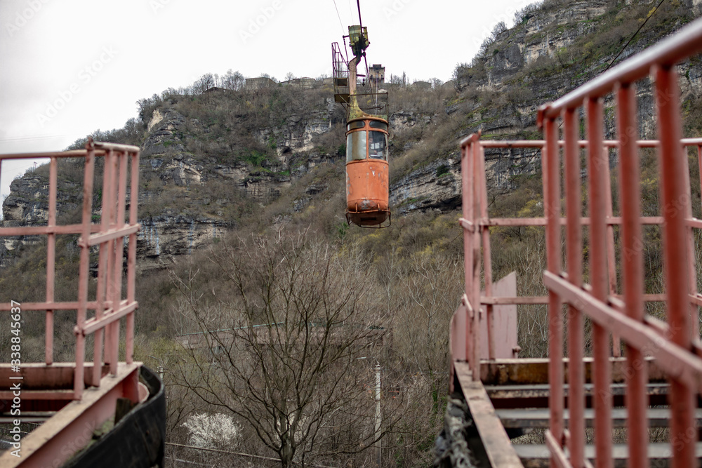 Red retro cable car cabin cableway cabin climbing uphill in Chiatura ...