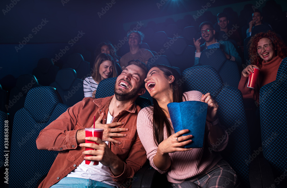 Group Of Cheerful People Laughing While Watching Movie In Cinema Wall ...