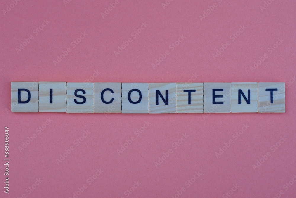 long gray word discontent made of small wooden letters with black font ...